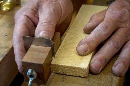 Sharpening scraper blades
